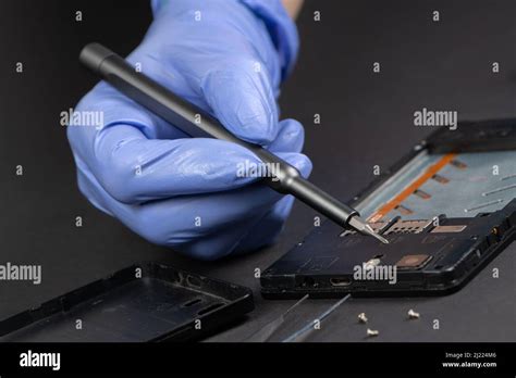 Process Of Mobile Phone Repair Hands Of A Service Worker Repairing Modern Mobile Phone Stock