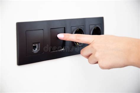 The Girl Presses The Button Of The Broken Electrical Switch Combined With The Socket Electric