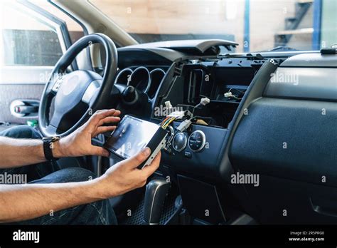 auto in car service process of installing modern 2 din radio sound