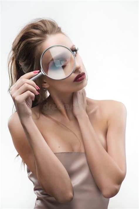 Beautiful Naked Shoulders Girl Looking Through A Magnifying Glass And Increases With It Her