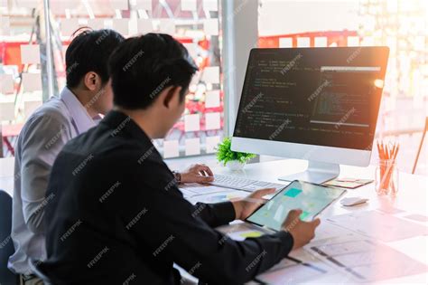 Premium Photo Attractive Two Young Programmers Team Developing Programming And Coding Mobile