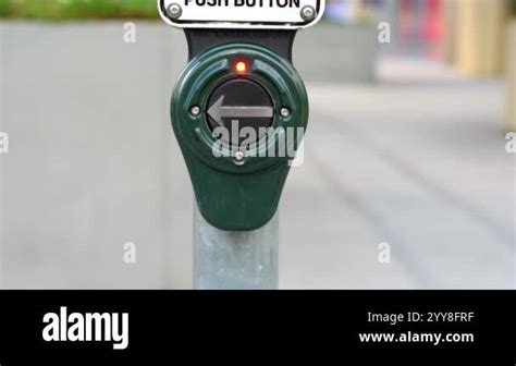 Detailed View Of A Pedestrian Signal Button Being Pressed Emphasizing