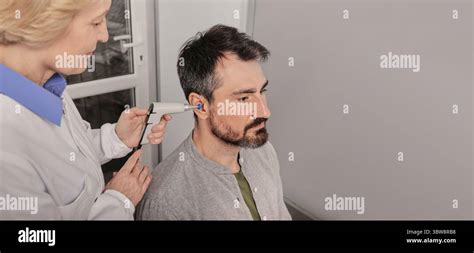 Experienced Audiologist With Tympanometer Probe Doing Tympanometry