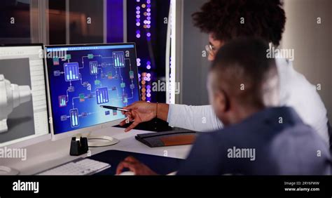 African American Engineers Monitoring Industrial Workplace On Computer