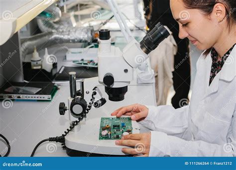 Beautiful Female Computer Expert Professional Technician Examining Board Computer In A