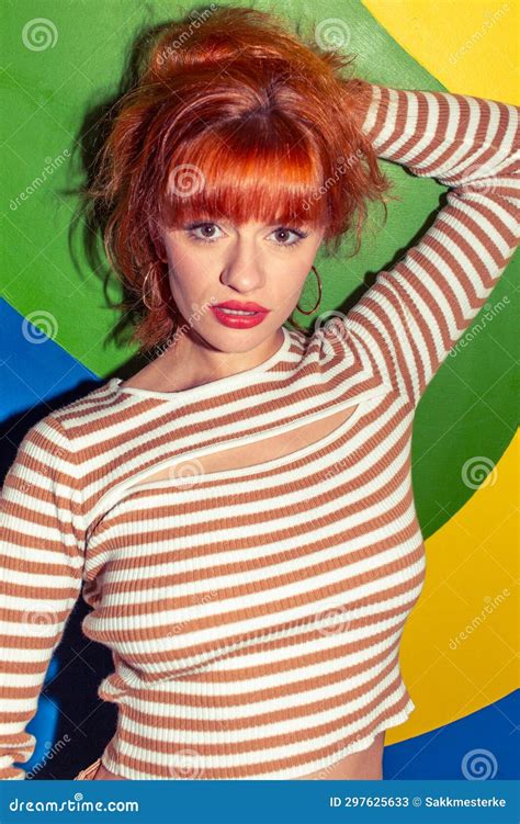 Young Redhead Caucasian Woman In Retro Style Of 70s Posing At Wall