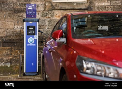 A Red Electric Vehicle Plugged In At A ChargePlace Scotland EV Charging