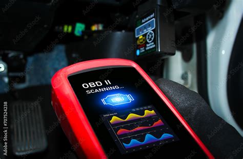 Auto Mechanic Checking ECU Engine System With OBD Wireless Scanning Tool And Car Information