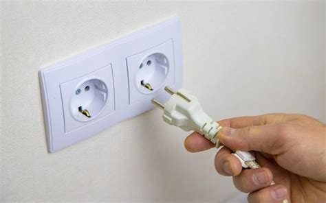 Premium Photo The Man Plugs In The Cord Selective Focus