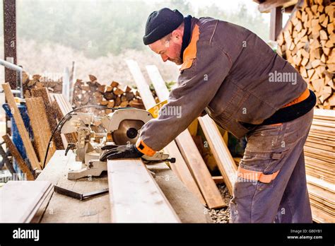 Carpenter Working Man Cutting Plank By Circular Saw Stock Photo Alamy