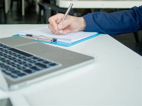 Business Woman Working At A Computer Writing A Note In Chart Finance