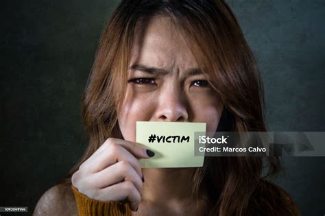 젊은 슬 프 고 절망적 인 아시아 중국 학생 여 자가 학대 가정 폭력과 고립 된 배경에 무력 느낌 왕 따의 피해자로 서 메시지 종이 들고 괴롭힘에 대한 스톡 사진 및 기타