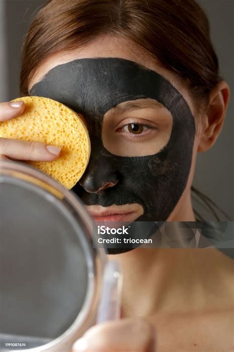 숯 얼굴 마스크 또는 검은 점토 진흙 그녀의 얼굴에서 검은 마스크를 제거 아름다운 여자 스튜디오 헤드 샷을 닫습니다 자연 화장품 개념 가꿔주기에 대한 스톡 사진 및 기타