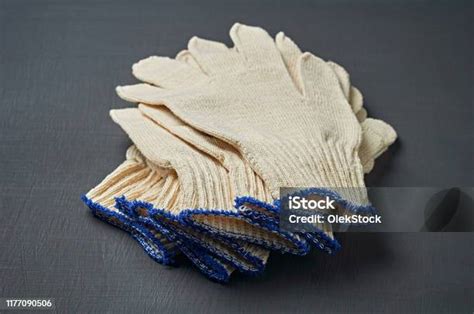 열심히 일하는 보호 새로운 흰색 섬유 장갑의 힙은 작업장에서 어두운 긁힌 콘크리트 테이블에 놓여 있습니다 클로즈업 가사 집안일에 대한 스톡 사진 및 기타 이미지 Istock