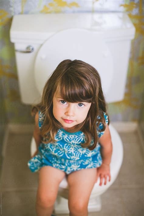 Blue Eyed Girl On Toilet By Stocksy Contributor Amanda Worrall