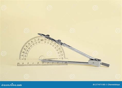 Protractor And Metal Compass On Yellow Background Royalty Free Stock