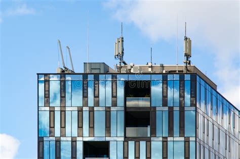 Cellular Antennas On Modern Building Roof Surface Reflects Clouds Stock Image Image Of