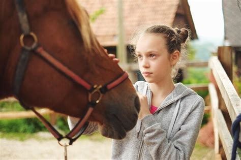 Premium Photo Girl With Horse Standing Outdoors