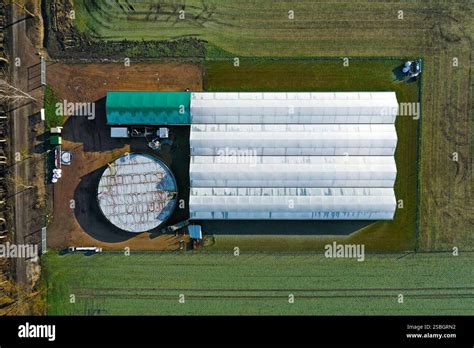 Aerial View Reveals A Modern Agricultural Complex Featuring Greenhouses