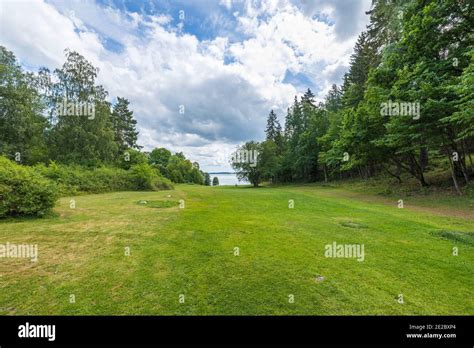 Beautiful Summer Nature Landscape View Greengrass Field On Front And Baltic Sea On Cloudy Sky