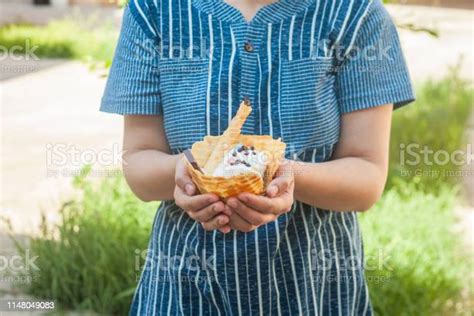 자연에서 피크닉을 하는 동안 와플과 맛 있는 아이스크림을 들고 젊은 여자 여름 음식 개념입니다 밝은 여름 날에 막대기로 맛 있는 아이스크림을 먹는 젊은 성인 개념에 대한