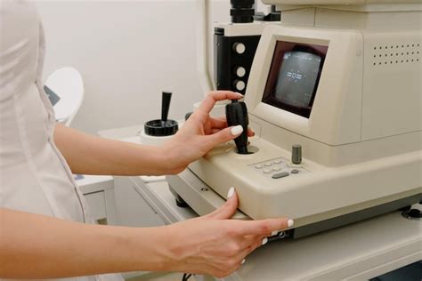 Premium Photo A Woman Is Using A Microscope To Check The Temperature Of A Patient