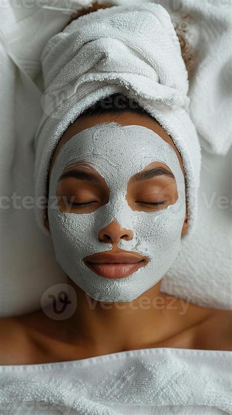 Woman With Clay Mask Lying Down White Towel On Head Facial Spa