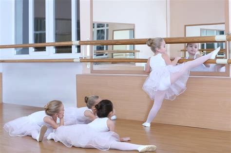Grupo de lindas meninas praticando balé na aula Foto Premium
