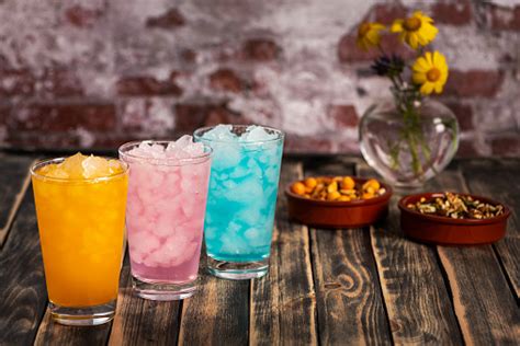 얼음으로 가득 찬 유리잔과 다양한 맛의 다채로운 청량 음료 소박한 나무 테이블 위에 모듬 견과류 병이 함께 놓여 있습니다 0명에 대한 스톡 사진 및 기타 이미지 Istock