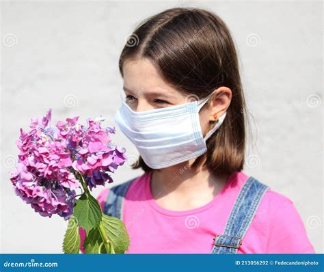 Beautiful Girl With Brown Hair And Surgical Mask With A Hydrange Stock