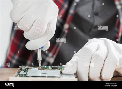 Technician Repairing Computer Motherboard With Screwdriver Stock Photo Alamy
