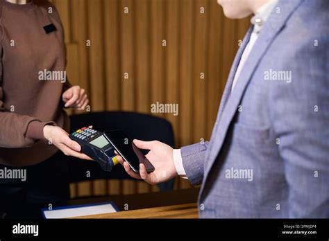 Woman Administrator Makes A Payment Through The Terminal Stock Photo Alamy