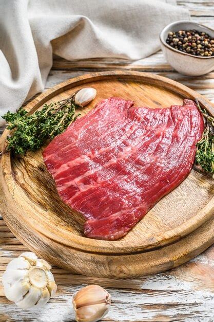 Premium Photo Raw Flat Iron Steak On A Cutting Board