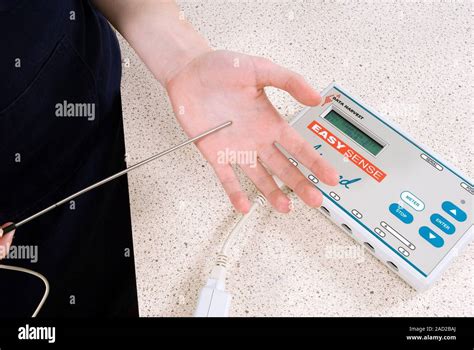 Temperature Probe And Data Logger Babe Holding An Electronic Temperature Probe Connected To
