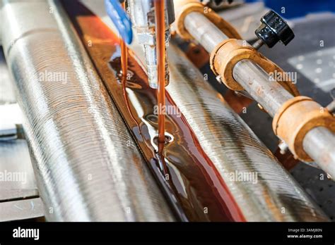 Precision Glue Spreading Machine Applies Adhesive With Expert Control In An Industrial Workshop