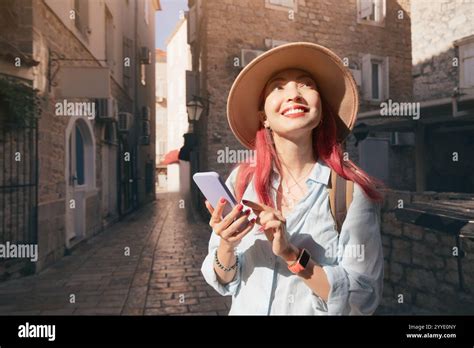 Tourist Using Mobile Phone App For Navigation While Exploring Budva Old Town Montenegro Stock