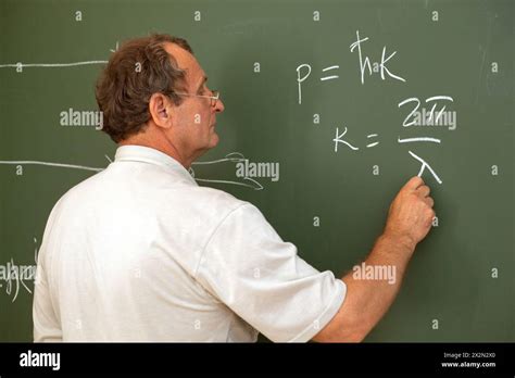 Scientist Solves Equation On Blackboard Back Stock Photo Alamy