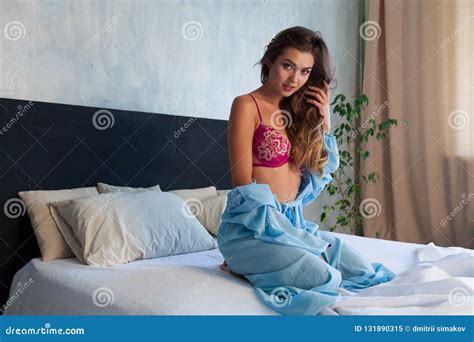 Portrait Of Beautiful Woman In Lingerie On The Bed In The Bedroom Stock