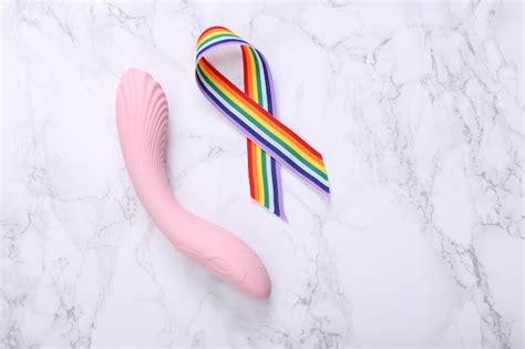 Premium Photo Sex Toy With Lgbt Rainbow Ribbon Pride Tape Symbol On Marble Background Top View
