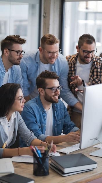 diverse team in modern office it programmers gather around computer talking finding solution