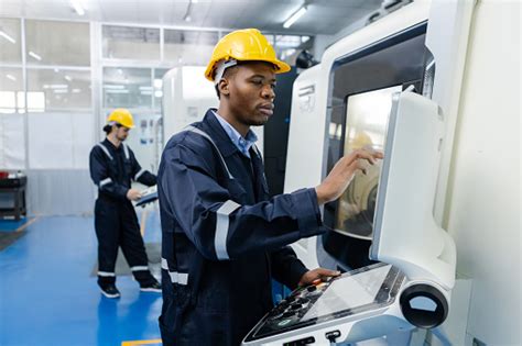 Man African American Engineer Using Computer Controlling Cnc Machine At Workshop Professional