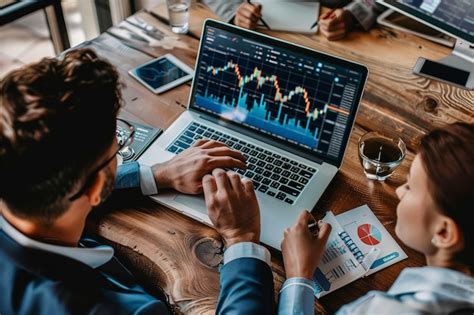 A Man Is Working On A Laptop With A Graph Showing That It Is Graphing