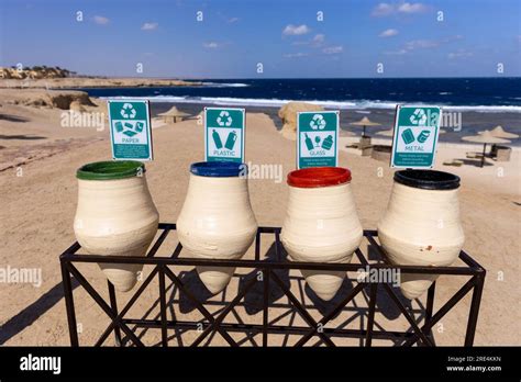 Four Containers For Garbage Sorting And Recycling Green Blue Red And Black Marks On Garbage