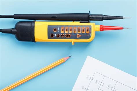 Premium Photo Two Pole Voltage Indicator With Electrical Drawings On A Blue Background