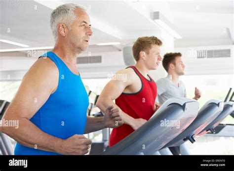 Group Of Men Using Running Machines In Gym Stock Photo Alamy