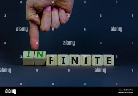 Finite Or Infinite Symbol Businessman Turns Wooden Cubes And Changes The Word Finite To
