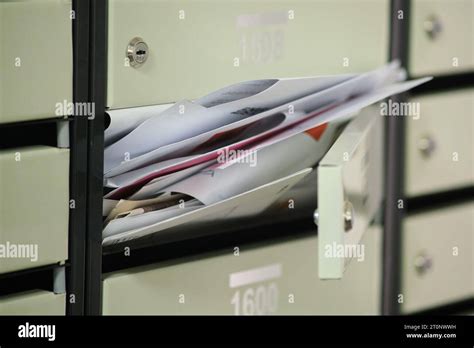 Paper Letters Lie In An Open Mailbox Filled With Spam Mailboxes In The Condominium Are