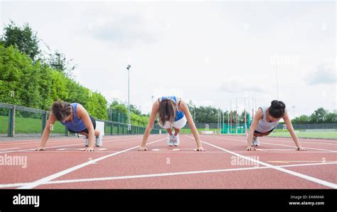 Three Woman Stretching On Running Track Stock Photo Alamy