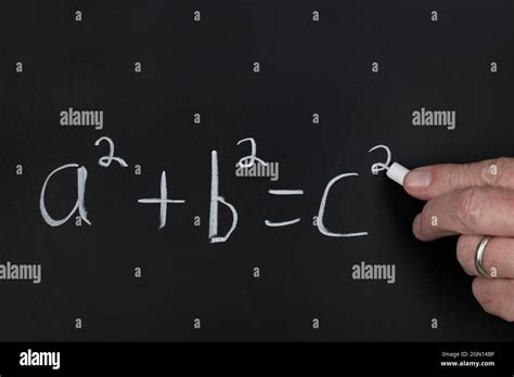 A Teacher Writes The Pythagorean Theorem Equation On A Black Chalkboard