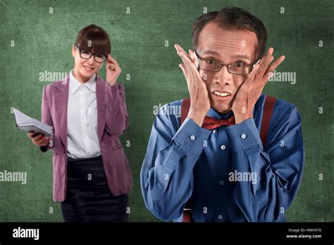 Asian Nerd Man Looking Shy With Beautiful Teacher Behind Him On Class Stock Photo Alamy